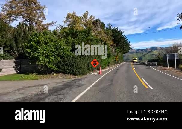 An ambulance travels through a winding road in Akaroa, New Zealand ...