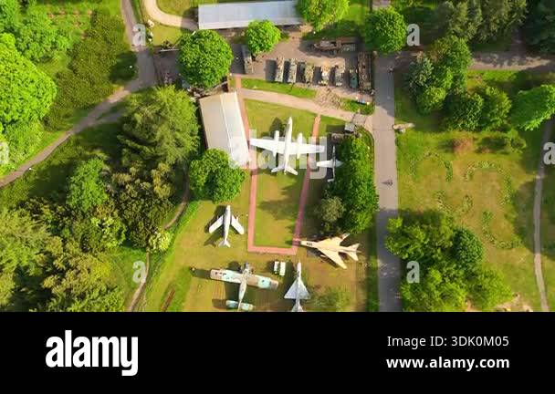 Aerial view of a green park in Poznan showing dense trees, a circular ...