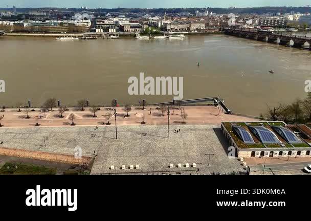 Drone video of Garonne riverfront with sparse pedestrians, trees ...