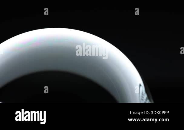 Close-up view of a soap bubble showing dynamic color reflections and ...