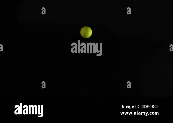 Yellow ball bouncing against a dark background Stock Video Footage - Alamy
