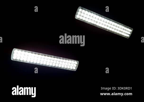 Two rectangular LED light bars illuminate against a solid black ...
