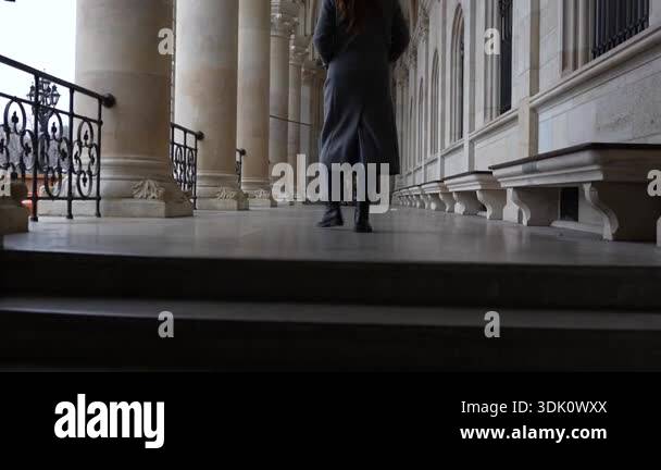 Woman walks through Vienna City Hall arches January 20 2025 Stock Video ...