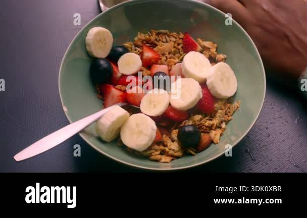 Person hands preparing delicious healthy muesli for breakfast Stock ...