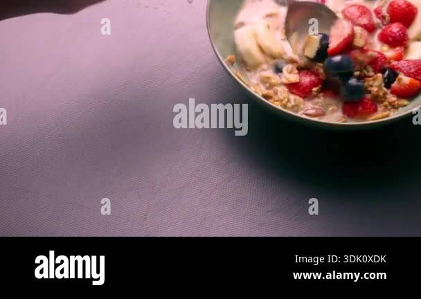 Person eating delicious healthy muesli cereal at breakfast time Stock ...