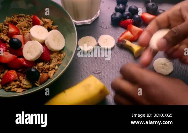 Person hands preparing delicious healthy muesli for breakfast Stock ...