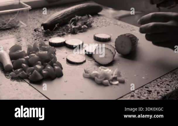 close up of person hands preparing fresh vegetables in kitchen at home ...