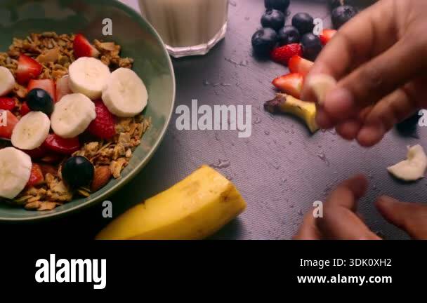 Person hands preparing delicious healthy muesli for breakfast Stock ...