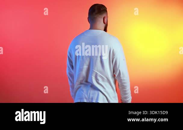 Bearded man standing confidently on colorful gradient background mid ...