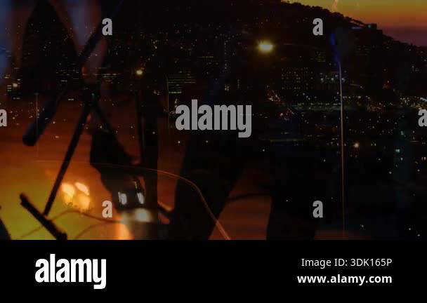 Female singer bringing mic to lips, singing, band playing rooftop gig ...