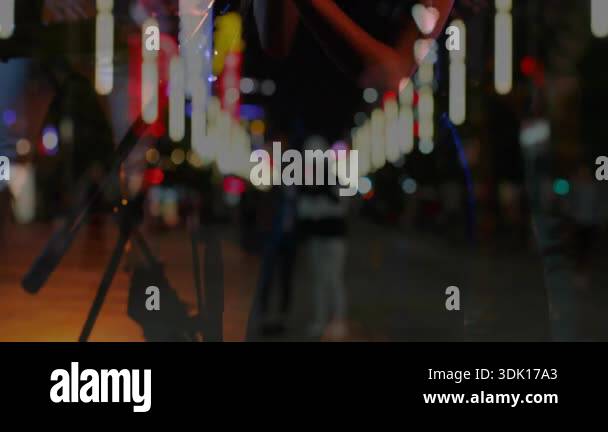 Blurring neon revealing vocalist gripping microphone singing music with ...