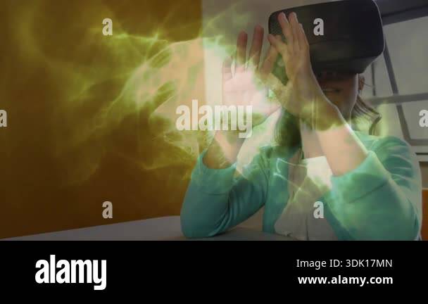 Student putting on VR headset and raising palms manipulating green ...