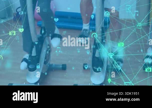 Workout partners starting pedaling bikes while streaming fitness icons ...