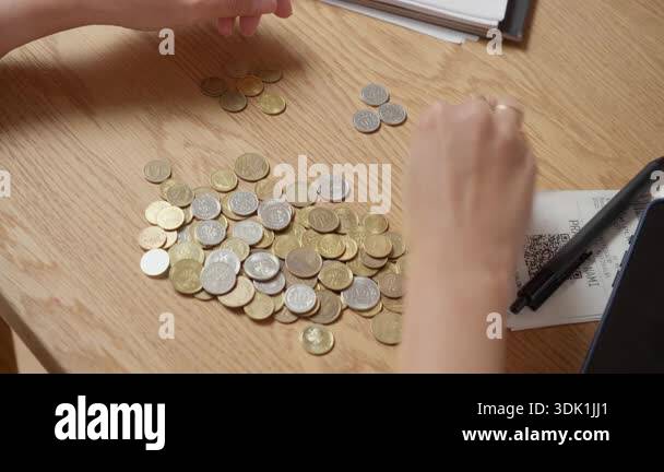 Woman hands sorting and organizing pile of metal coins cash at home ...