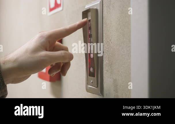 Finger pressing numbers on digital keypad intercom to enter access code ...