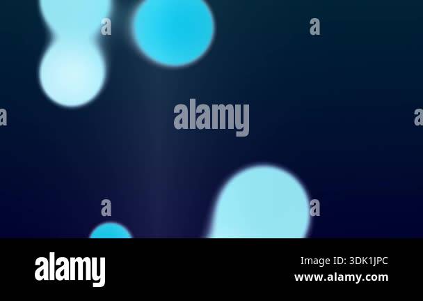 Soft blue bokeh light orbs drifting in a dark background creating a ...
