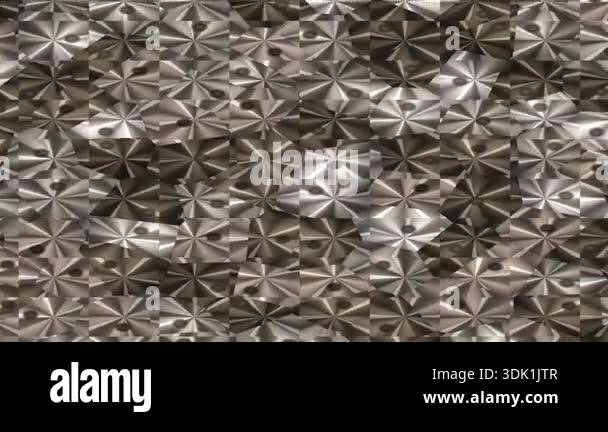 Close up view of a reflective metal surface with a repeating star ...