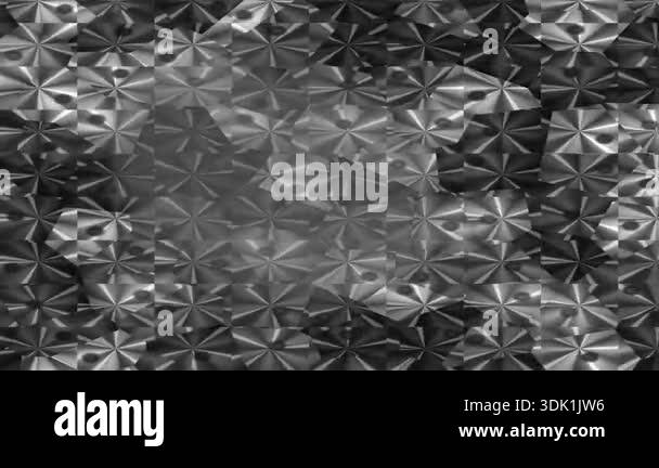 Sequence of grayscale close ups showing a reflective geometric metal ...