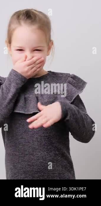 vertical Portrait of preeten girl kid smelling something stinky and ...