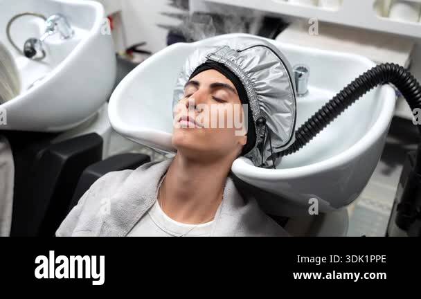 High angle view of a young man with his eyes closed, receiving a ...