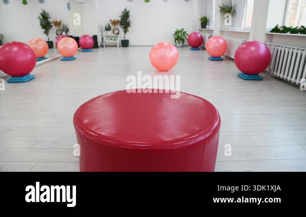 Spacious fitness studio interior with natural light, white walls, green ...