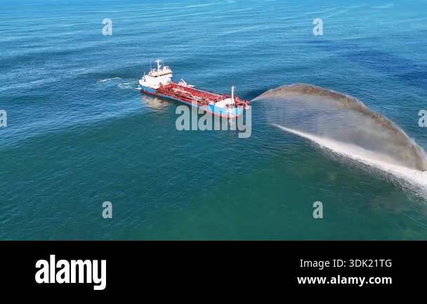Aerial view of a dredging ship pumping sand into the ocean, showcasing ...