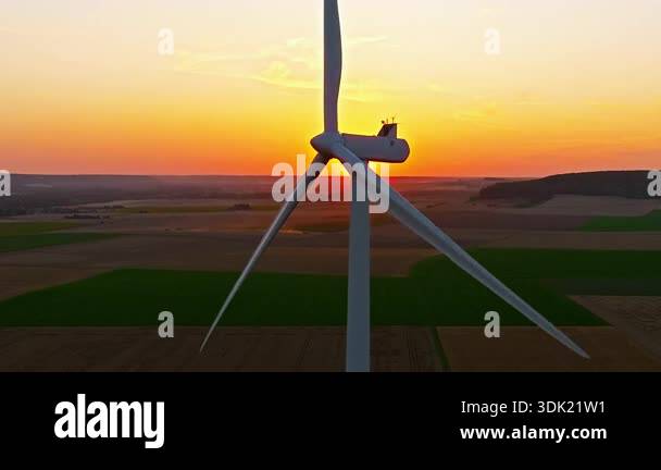 Aerial view of windmills turbine rotating by wind at sunset ...