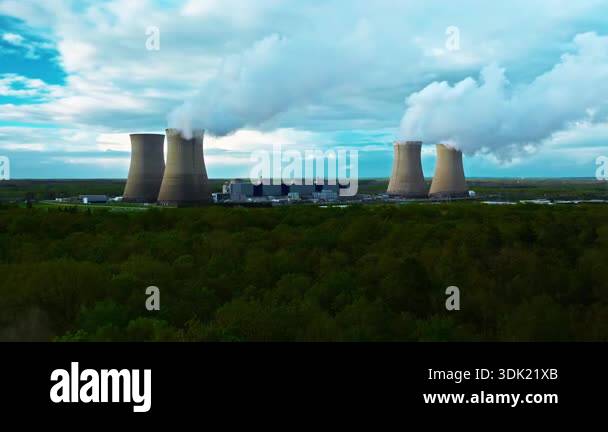 Aerial view nuclear power plant. Steam rises from the huge chimneys of ...