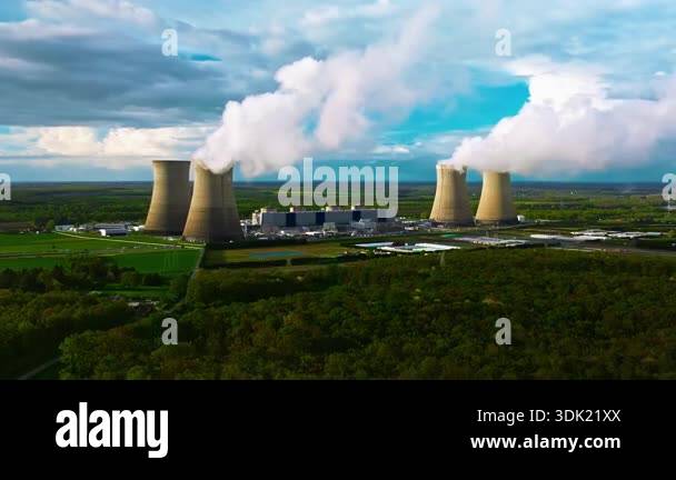 Aerial view nuclear power plant. Steam rises from the huge chimneys of ...