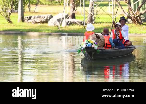 Family enjoying boat ride together in peaceful park lake setting Stock ...