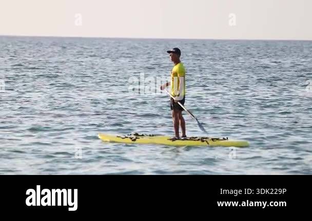 Man paddleboarding calmly on ocean at Karon Beach, Phuket, Thailand ...