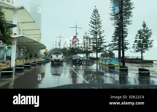 Rain-soaked streets and swaying trees as Cyclone Alfred nears Gold ...