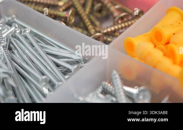 Sorting screws and nails into different boxes for better storage Stock ...