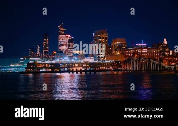 City skyline at night with lights reflecting on water. The city skyline ...