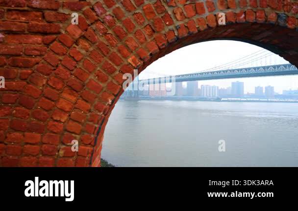 Brick arch view of Manhattan Bridge. Manhattan Bridge framed by brick ...