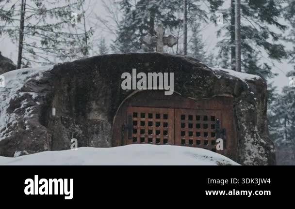 Snow Covered Stone Cave With Gate, Weathered Rock Shelter Carved Into ...