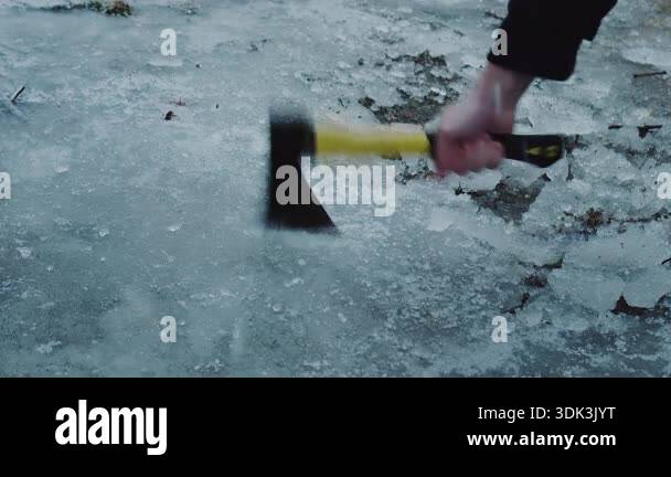 Hand Swinging Yellow Axe On Ice, Breaking Thick Frozen Surface Into ...