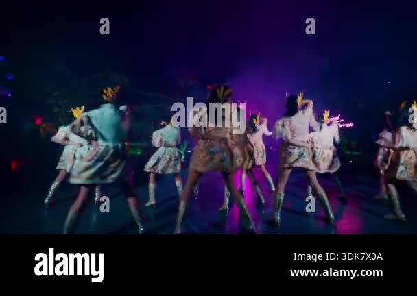 Low angle shot of dancers in a night parade. The performers execute ...