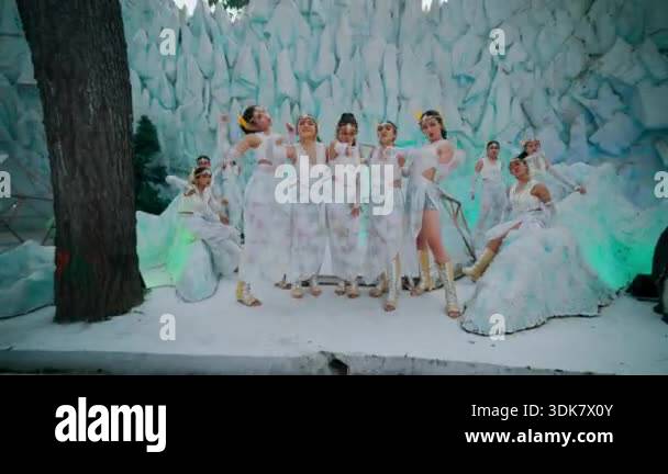 A cheerful group of dancers dressed as ice fairies posing together in ...