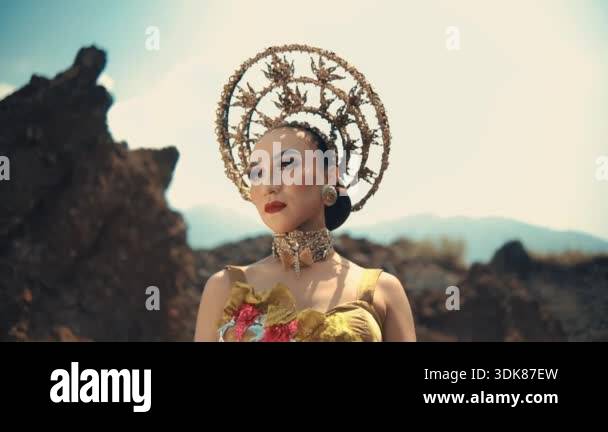 Cinematic shot of a woman in an avant-garde golden costume and halo ...