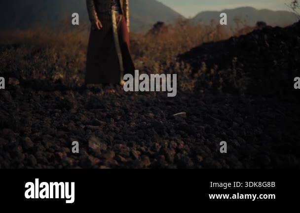 A man in a royal traditional costume walks confidently towards the ...