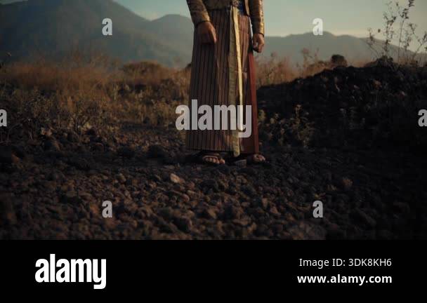 Mid-shot focusing on the lower half of a man wearing traditional ...