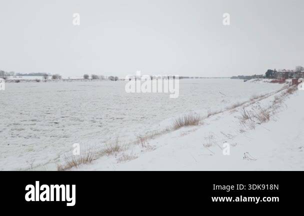 Frozen Vistula river stretching through snowy Poland landscape during ...