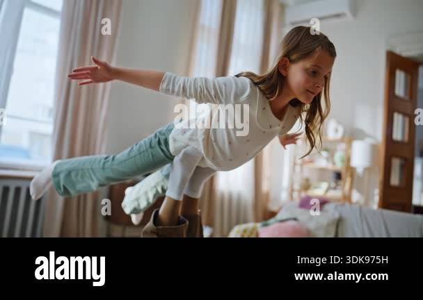 Cute girl playing mother holding balance indoors closeup. Caucasian mom ...