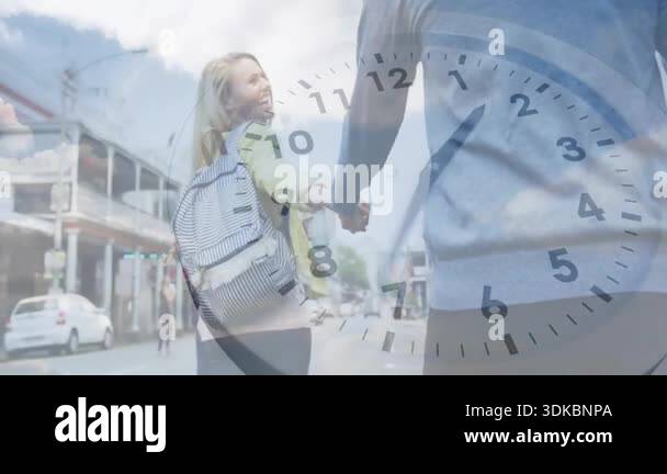 Couple entering frame walking holding hands under clock overlay ...