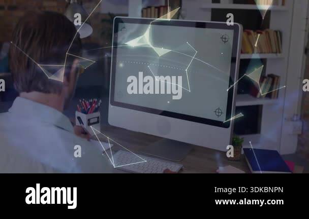 Man scribbling notes facing screen at desk visualizing tech network ...