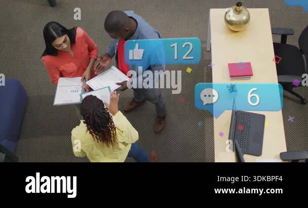 Three colleagues reviewing binders in business office as animated ...