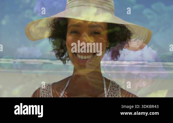 Modeling woman posing for fashion shoot on beach, drifting floral ...