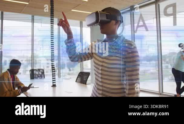 Female coworker securing VR headset and activating technology data ...