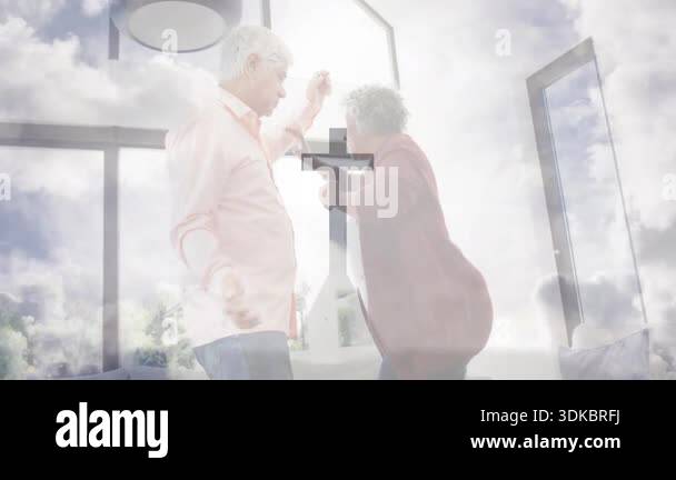 Senior couple lifting hands starting dancing in living room, showing ...